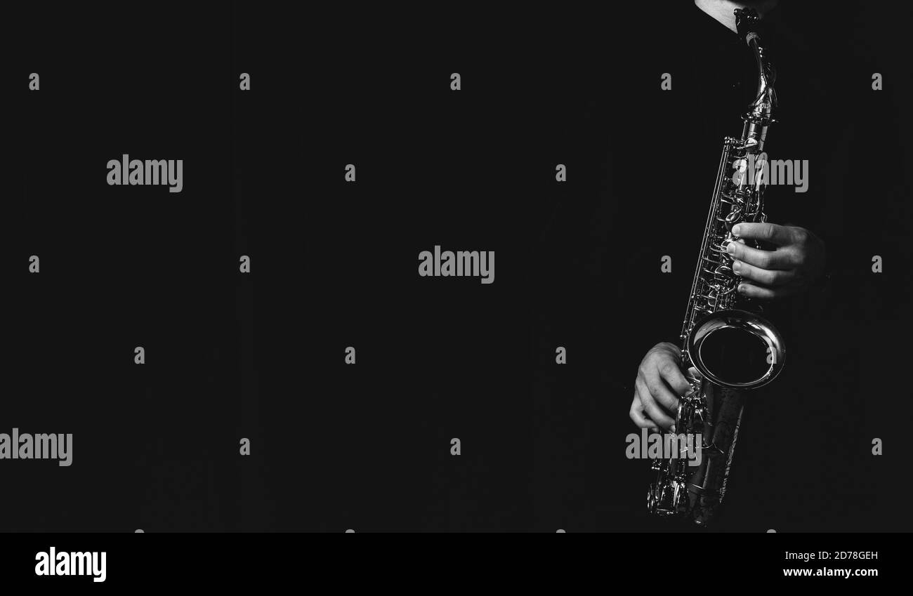 Grayscale shot of a cool and handsome guy playing his saxophone ...