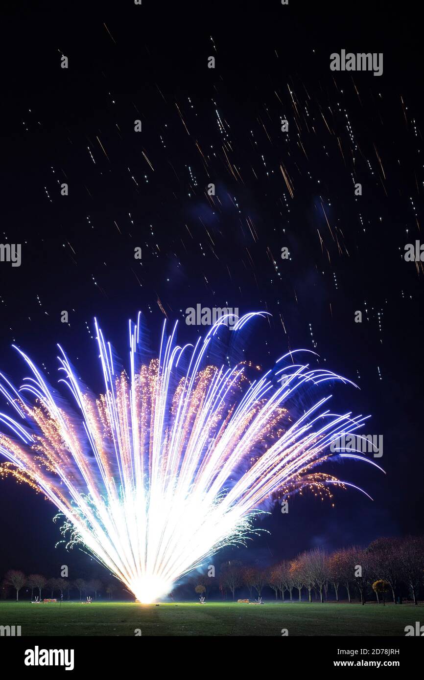 Spectacular and colourful firework display set against a dark Autumn ...