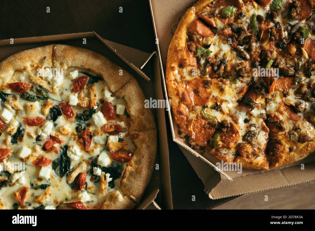 Two pizzas in boxes on table. Top view Stock Photo - Alamy