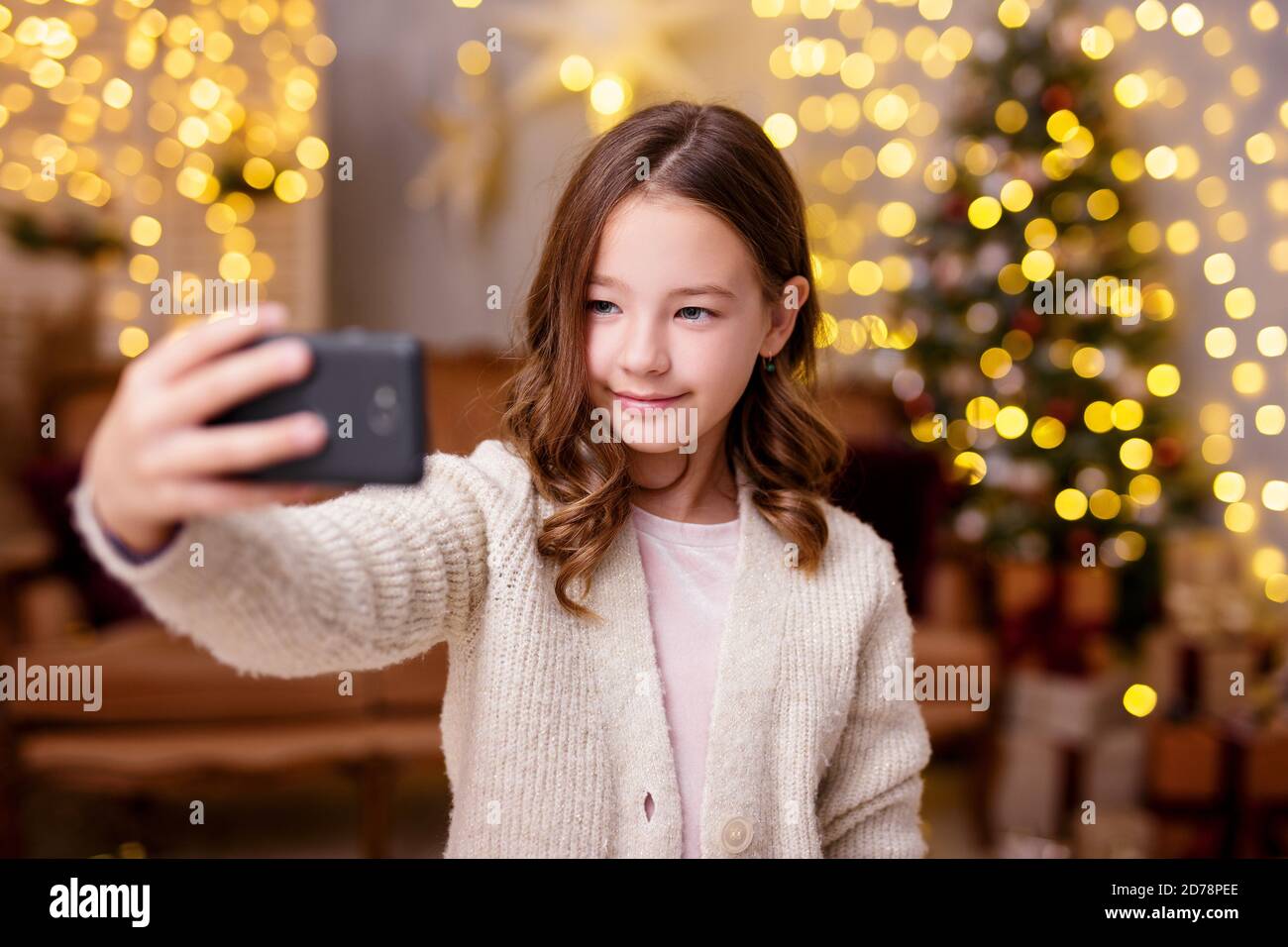Christmas and new year concept - cute little girl taking selfie photo ...
