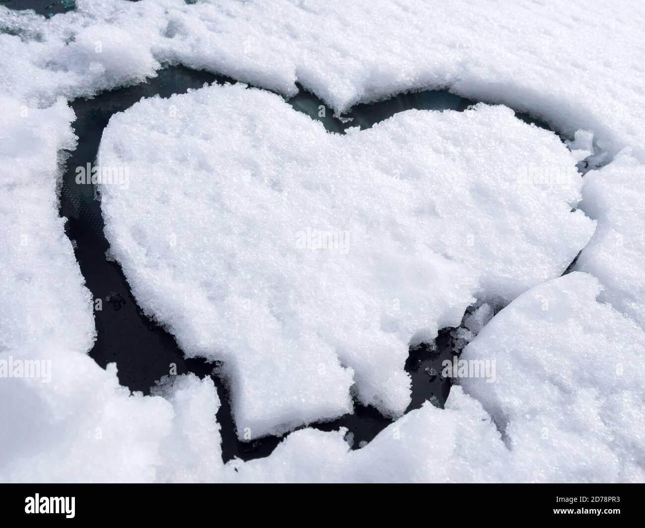 Snow funny background in the shape of a heart Stock Photo - Alamy