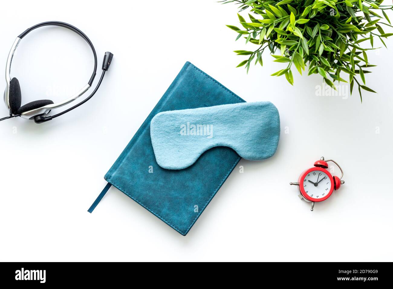 Reading book before going to bed. Sleeping accessories on the table ...