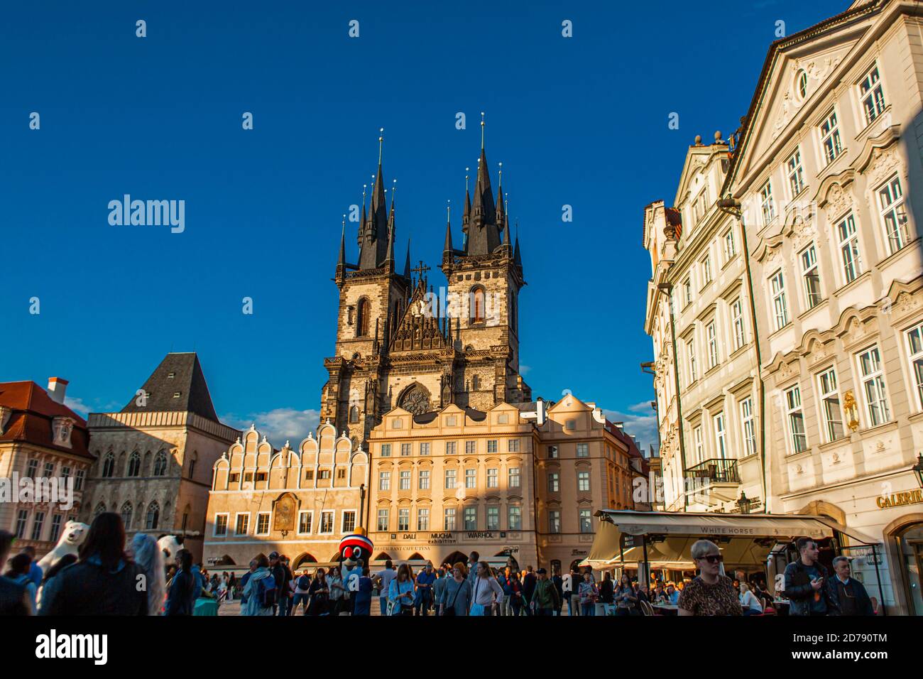 Tyn Temple on the Old Town Square in Prague. A crowd of tourists walk ...