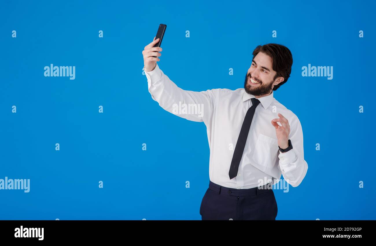 Young bearded businessman talking on the phone on facetime . A man in a ...