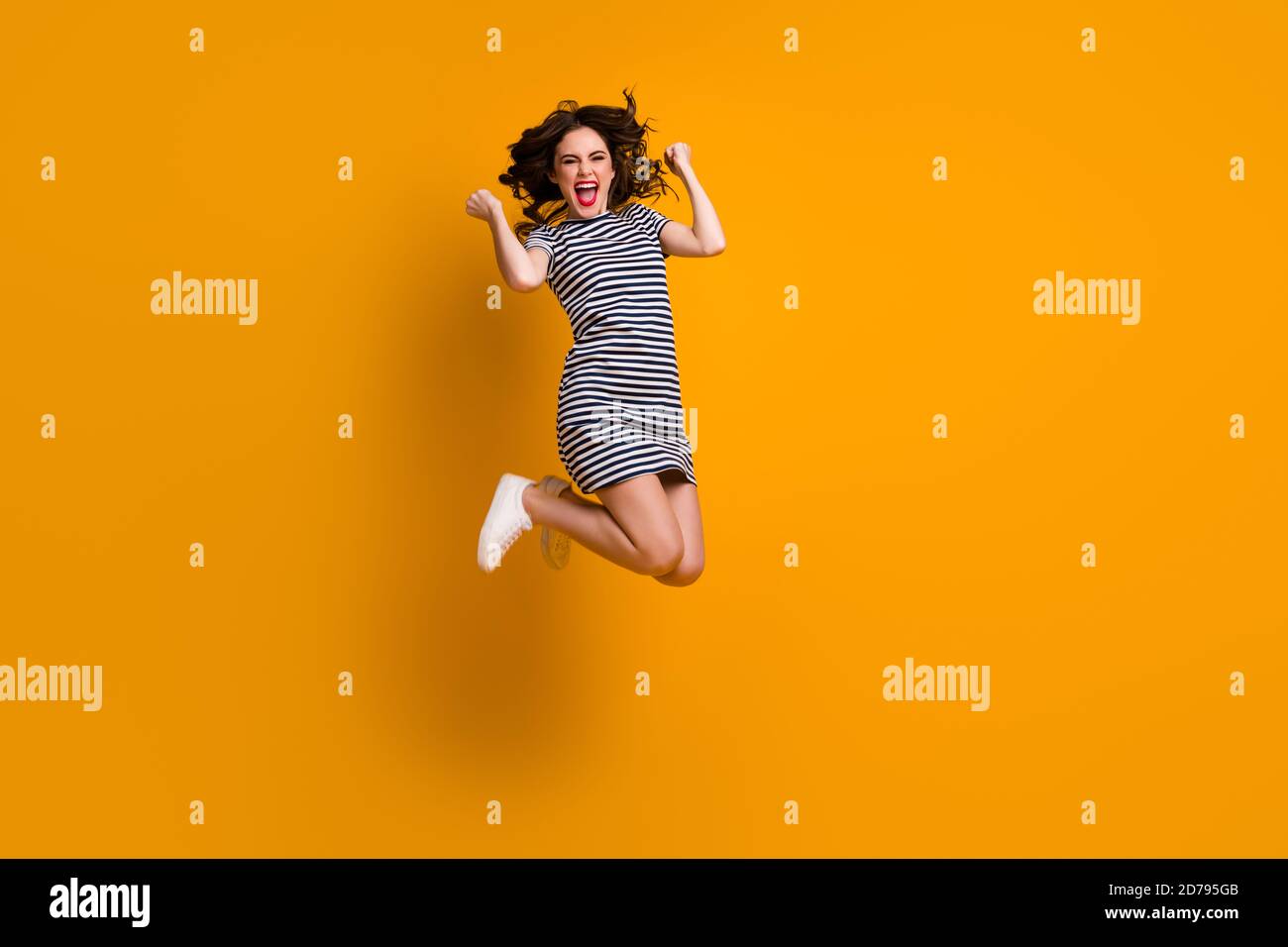 Full length photo of crazy curly lady jump high raise fists celebrate ...