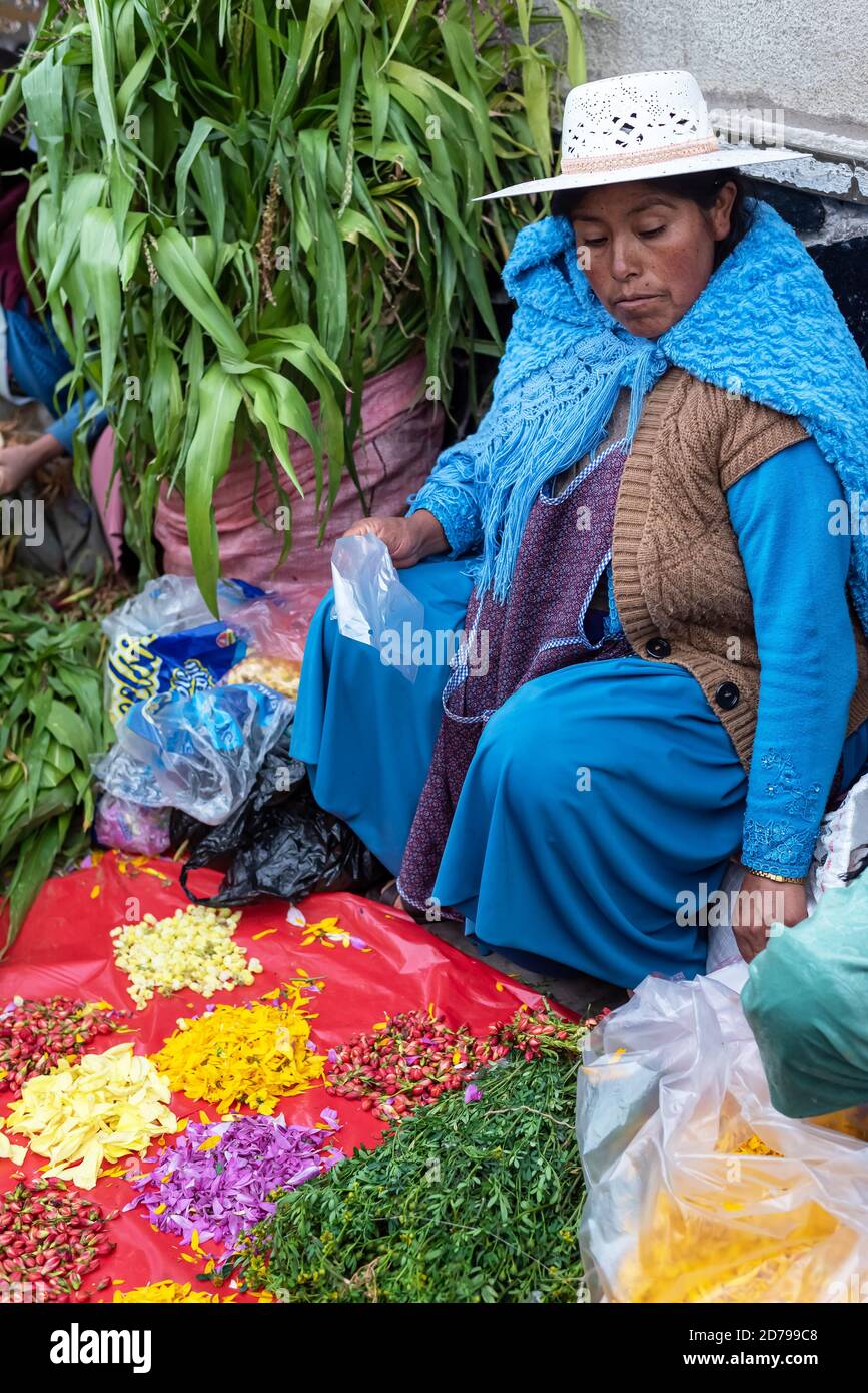 February 24, 2020: Woman wearing traditional clothes and selling petals ...
