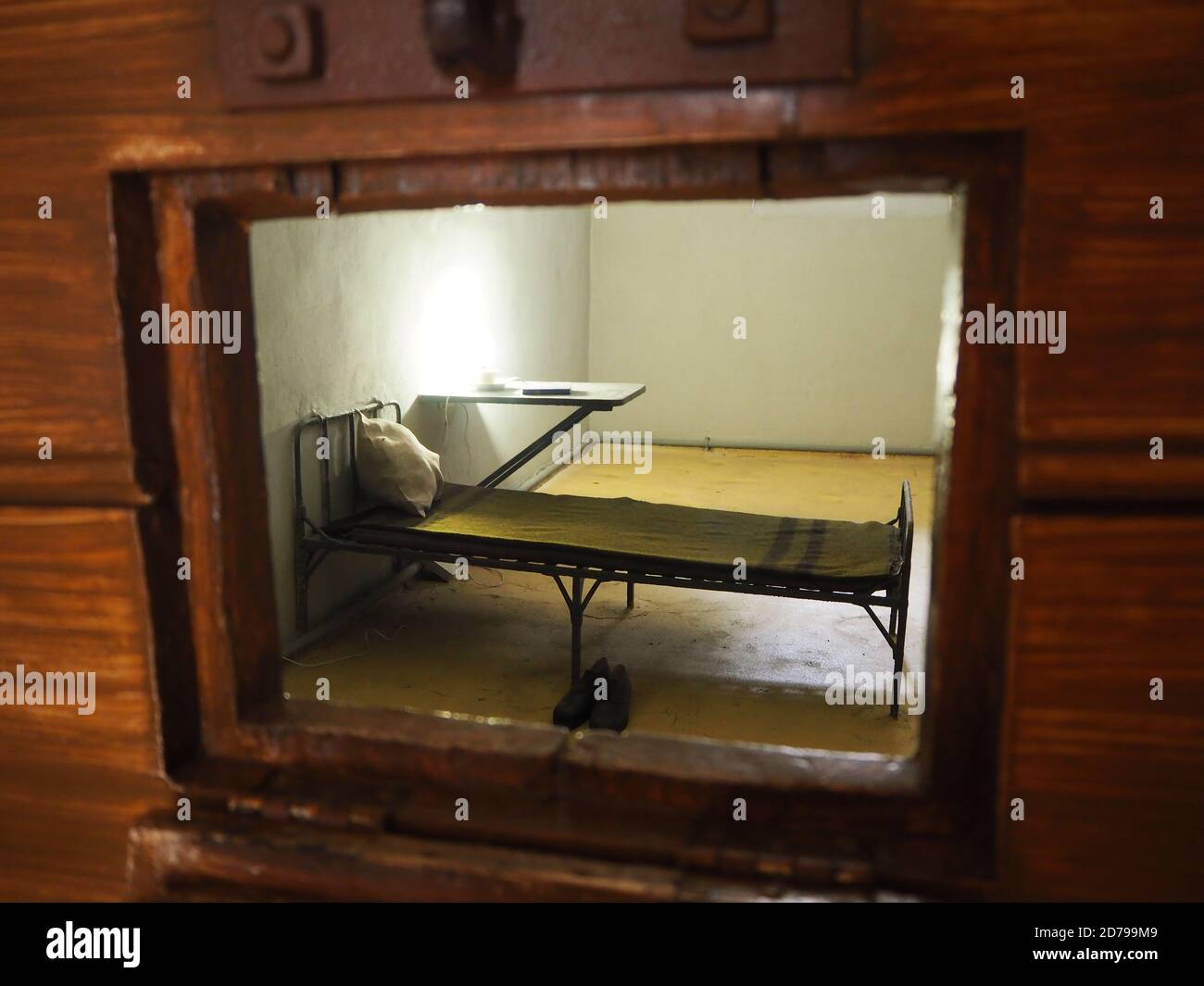 Prison cell with bed and table, seen through the prison door Stock ...