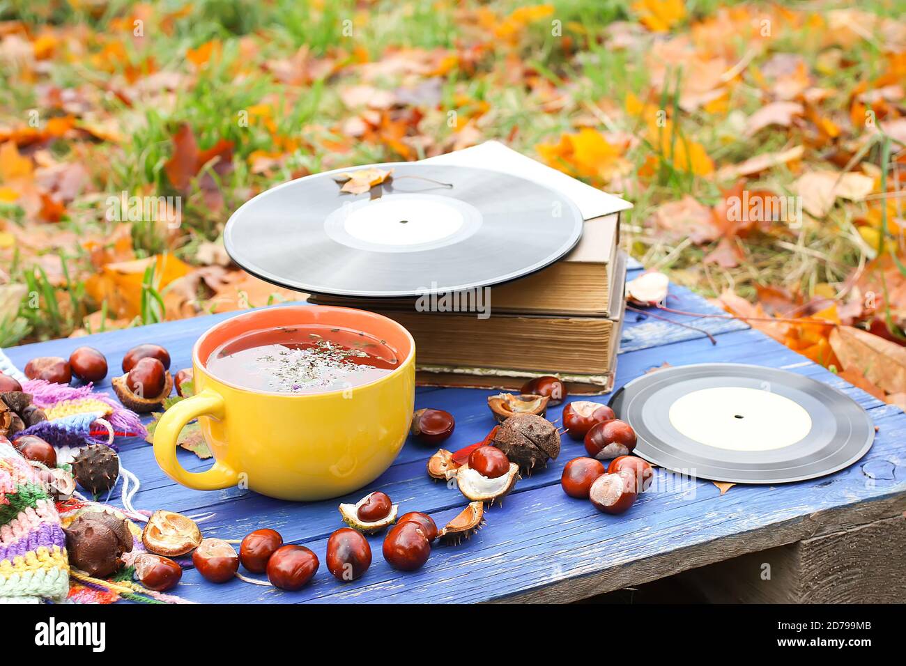 Autumn composition of yellow ceramic cup of herbal tea and vintage ...