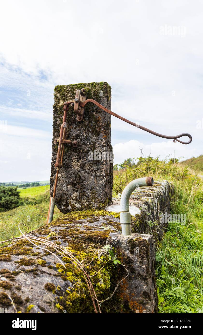 Wrought iron pump handle on an old water pump at a bridge over the ...