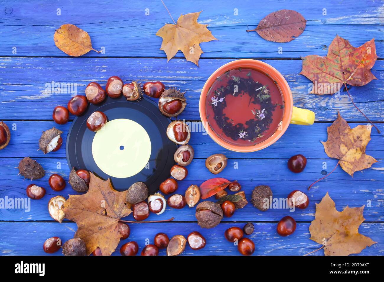 Yellow ceramic cup of herbal tea and vintage vinyl records on aged ...