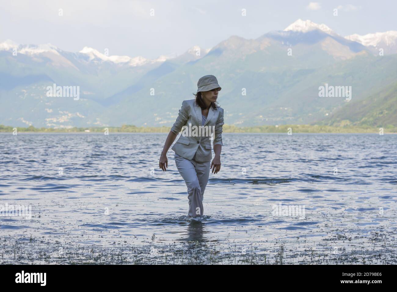 Woman Standing in a Flooding Alpine Lake Maggiore with Snow-capped ...