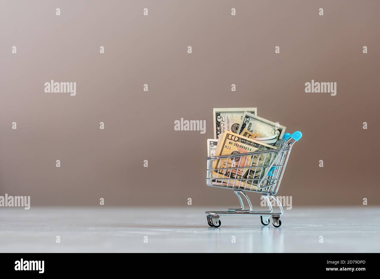shopping cart full of dollar bills , business, finance, economy concept ...