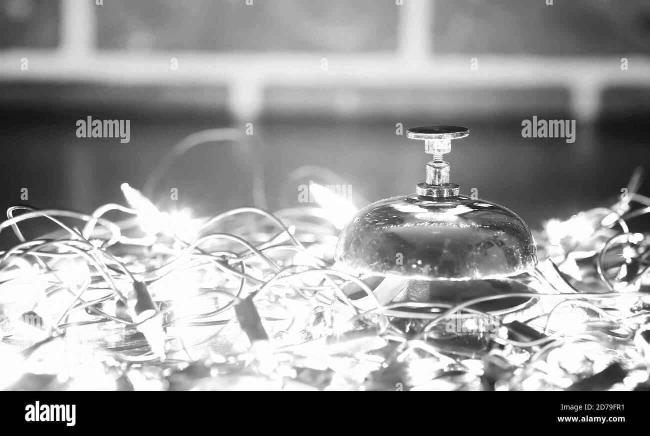 reception bell on the table and shining garland background Stock Photo ...