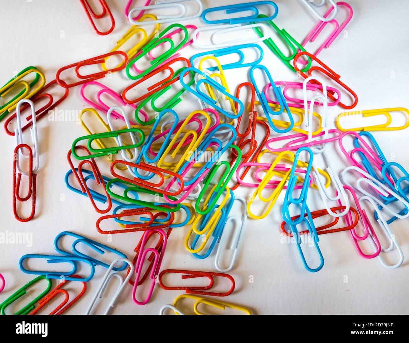 Colorful paper clips on a white background Stock Photo - Alamy
