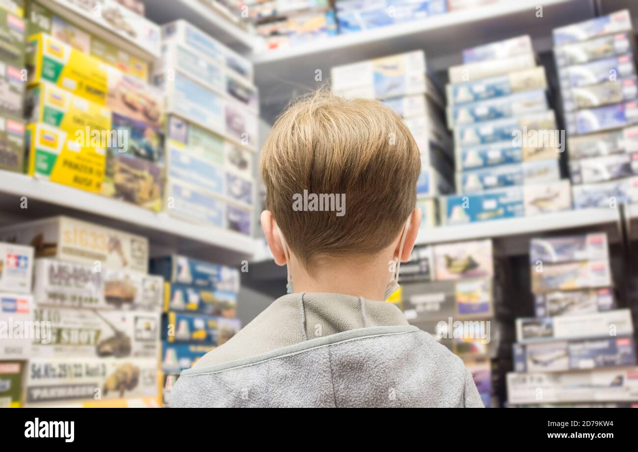 5 years little boy observing model building items displayed at hobby ...