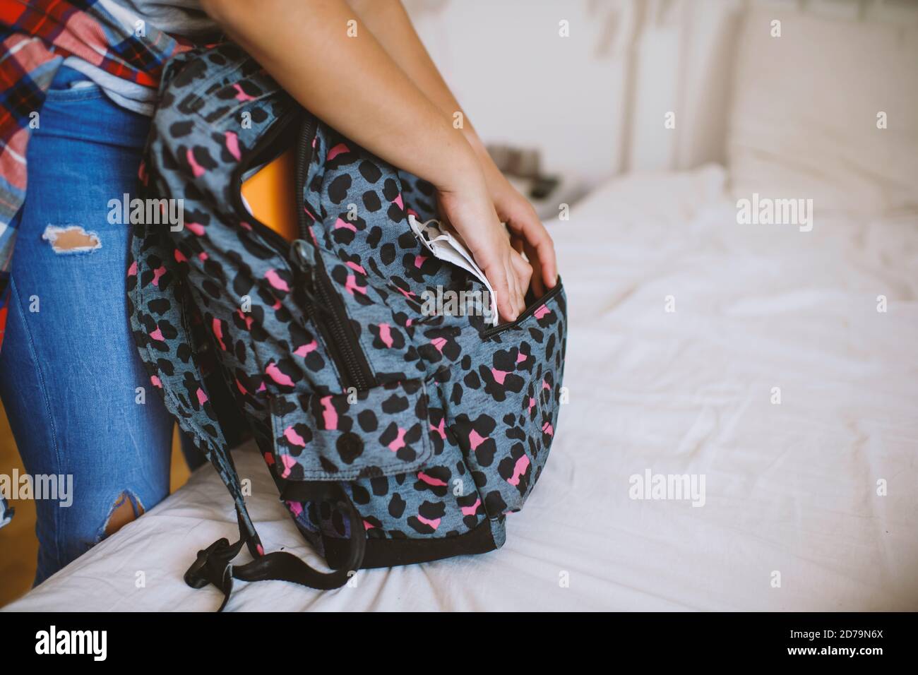 Child backpack putting book hi-res stock photography and images - Alamy