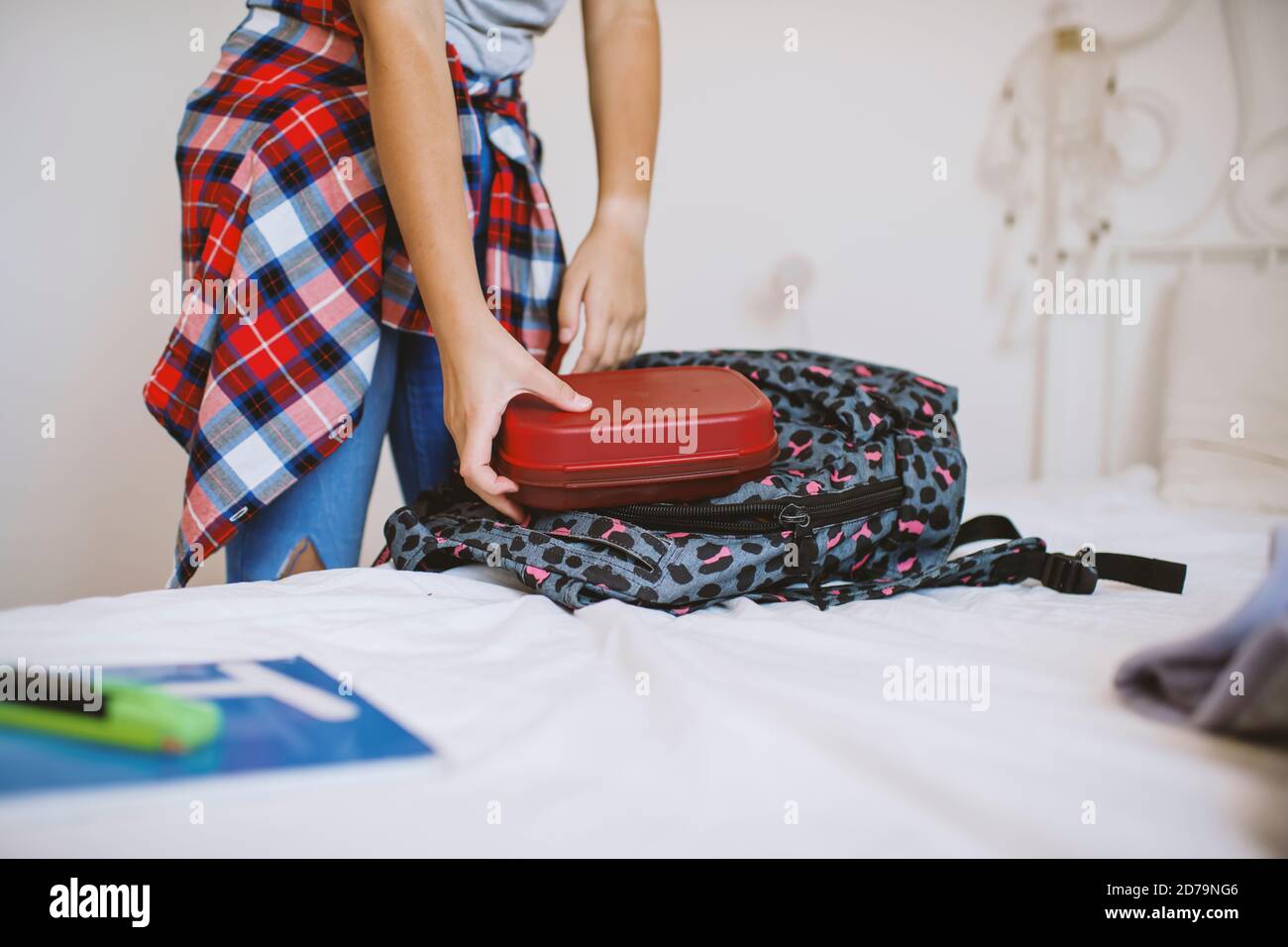 School girl putting school supplies into backpack Stock Photo - Alamy