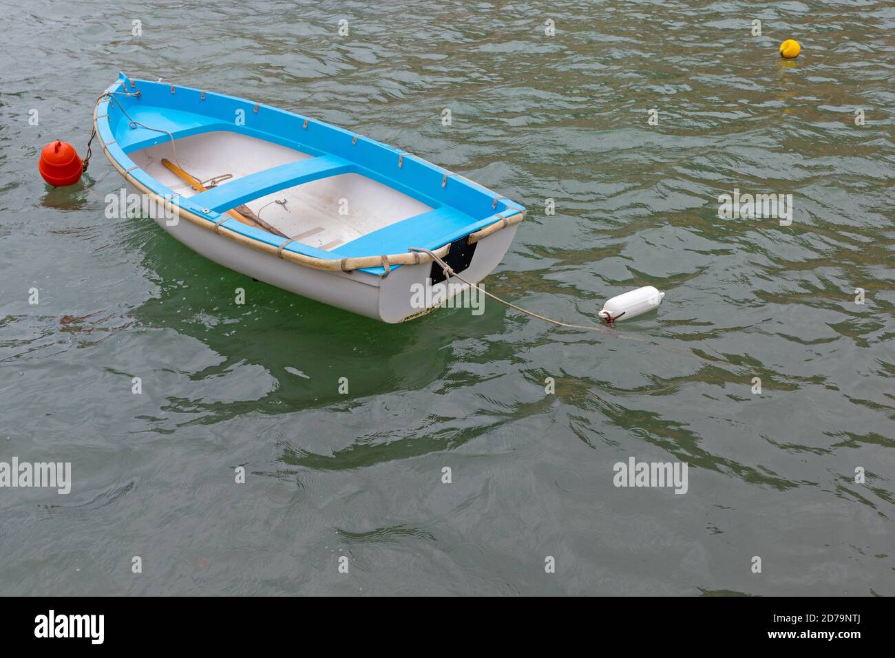 Small Plastic Dinghy Boat Moored at Sea Stock Photo - Alamy