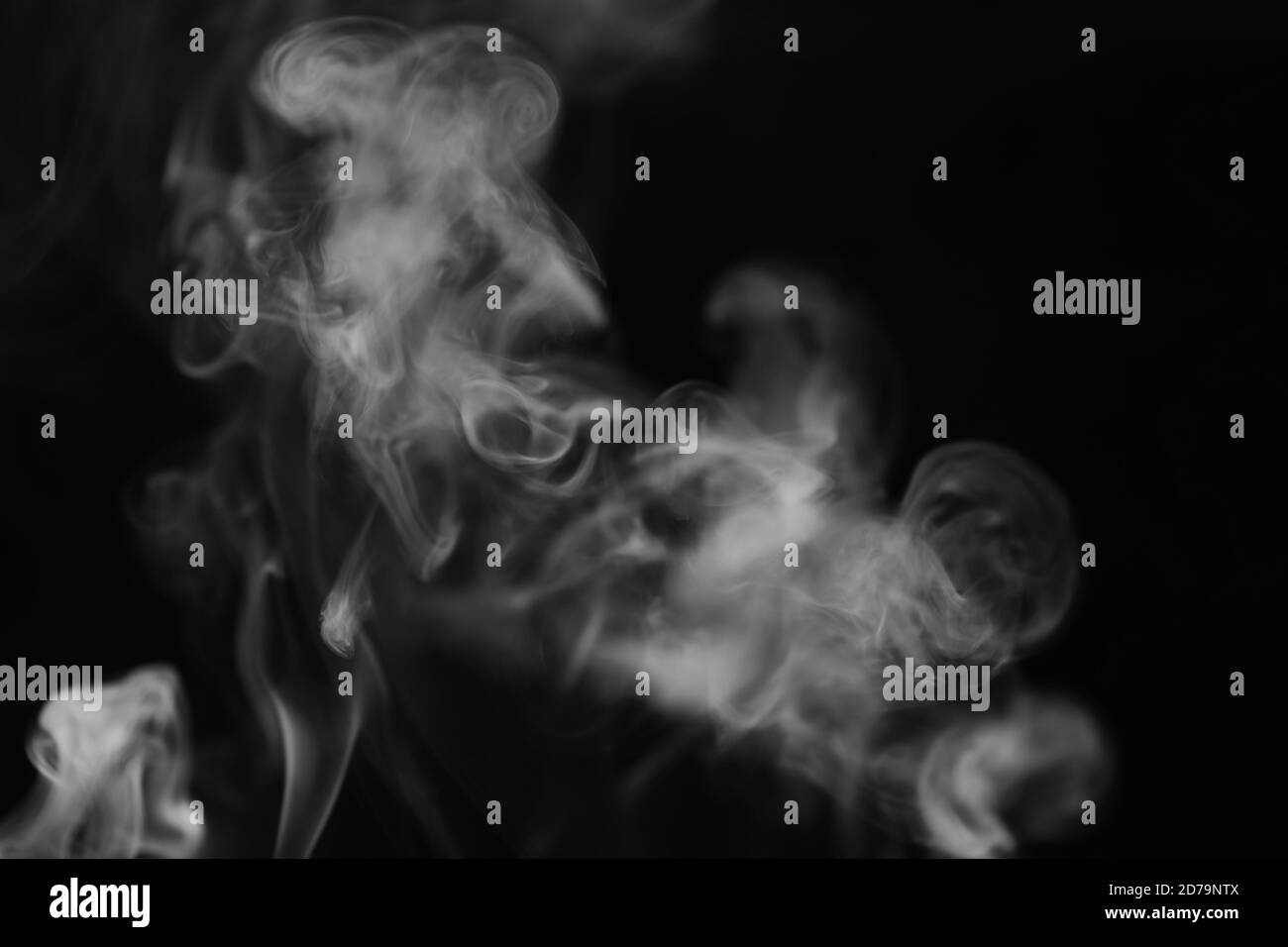 White smoke on a black background. Texture of smoke. Clubs of white ...