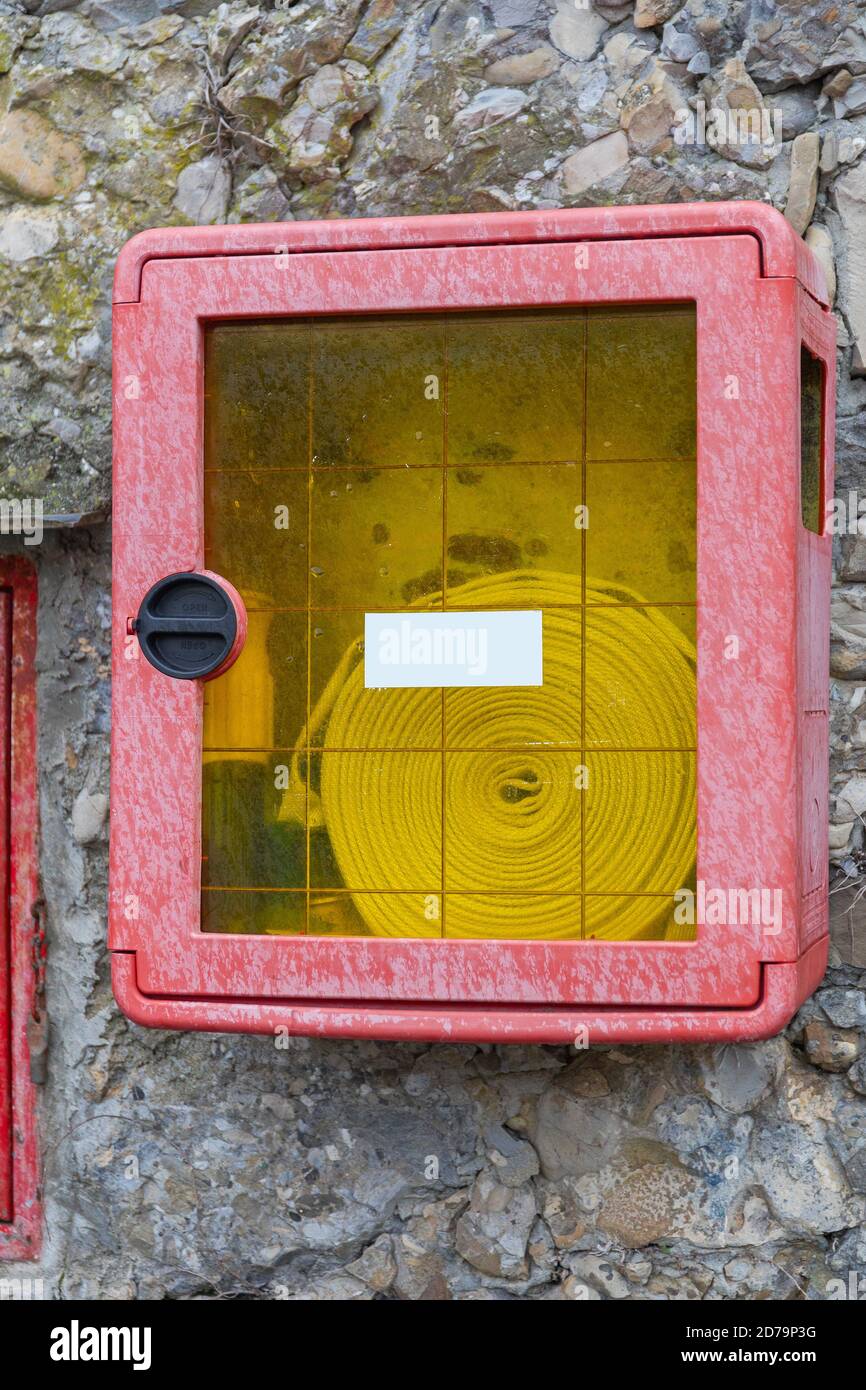 Fire Hose Coil in Box at Wall Stock Photo - Alamy