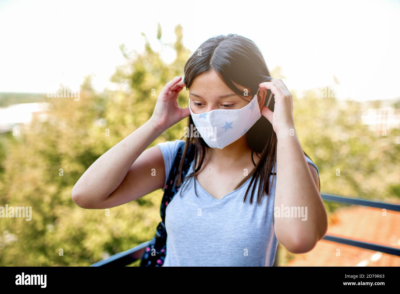 Caucasian girl putting on face personal protective face mask Stock ...