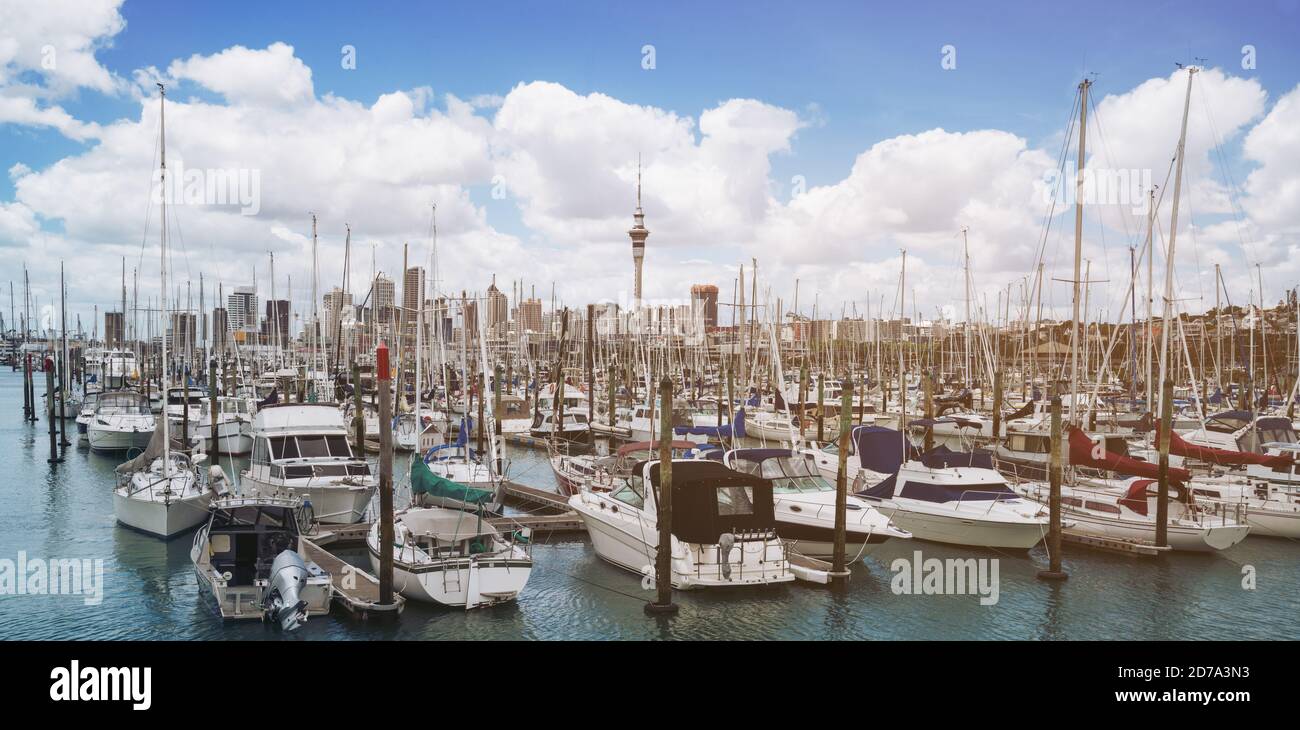 Yacht at harbour in Auckland with city skyline and Auckland Sky Tower ...