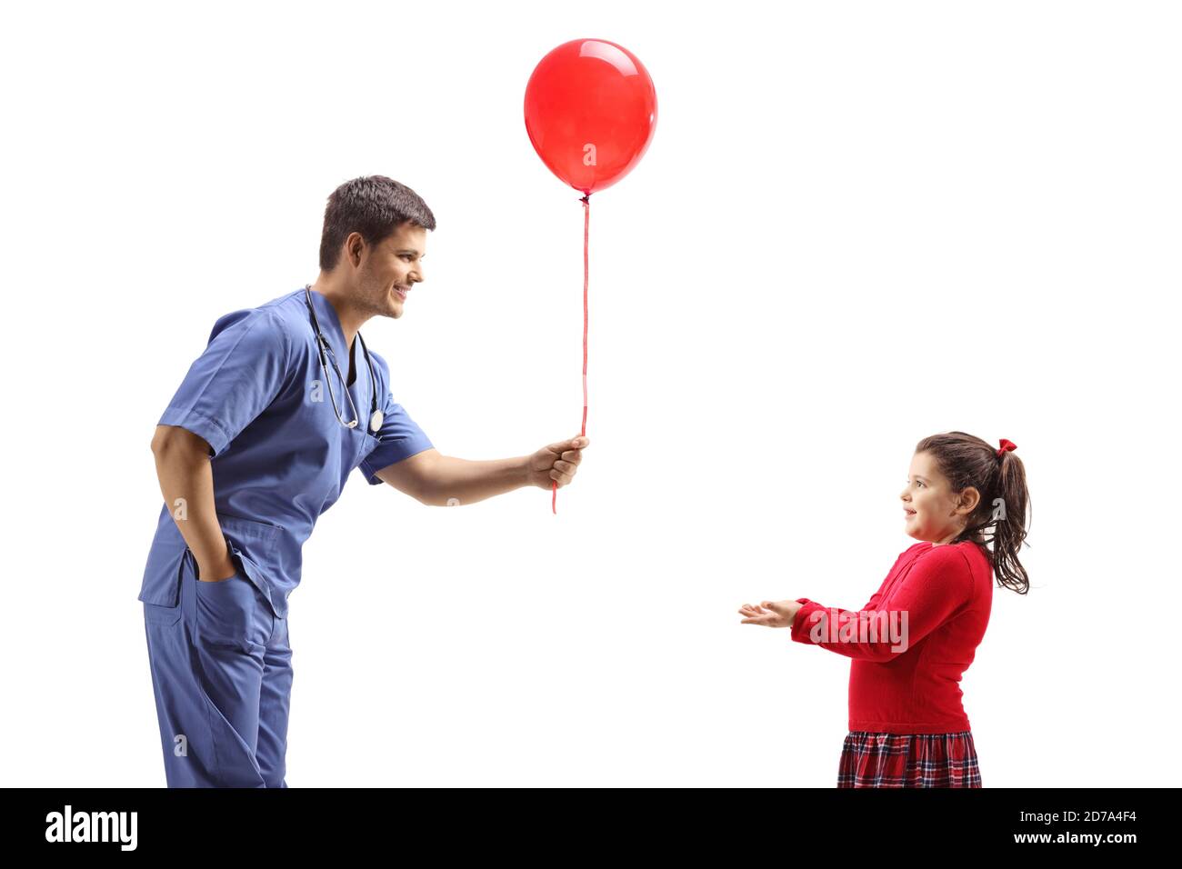 Doctor giving a red balloon to a little girl isolated on white ...