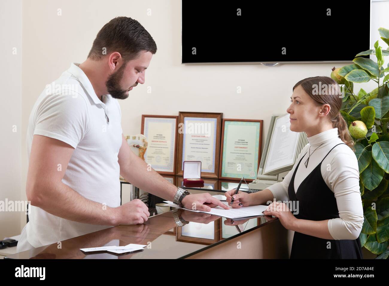 Young man at hospital reception desk hi-res stock photography and ...