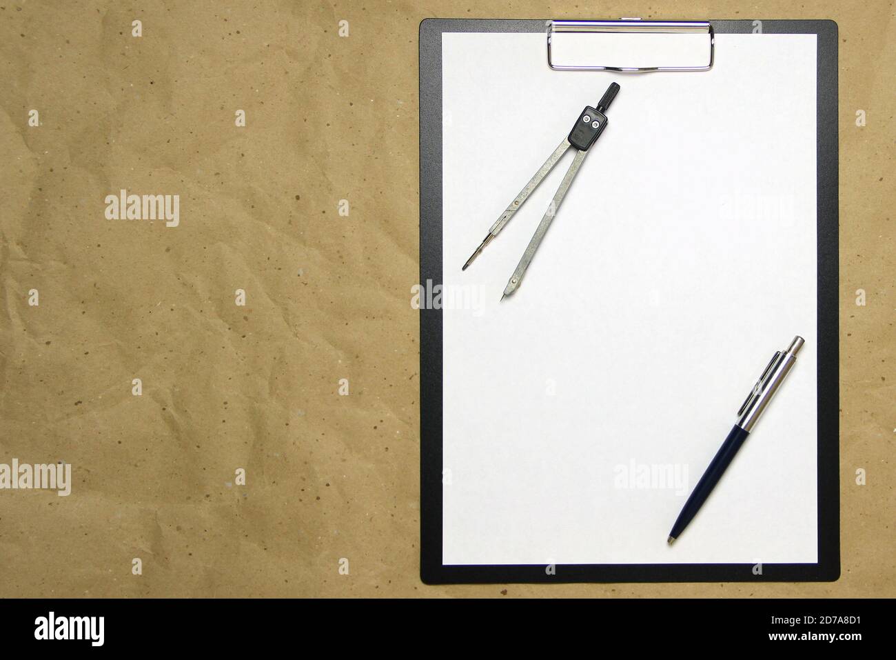 A tablet with a white sheet of A4 format on a beige craft paper. Stock ...