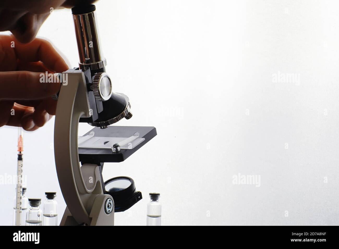 Research laboratory. Test tubes and microscope on the table on a white ...