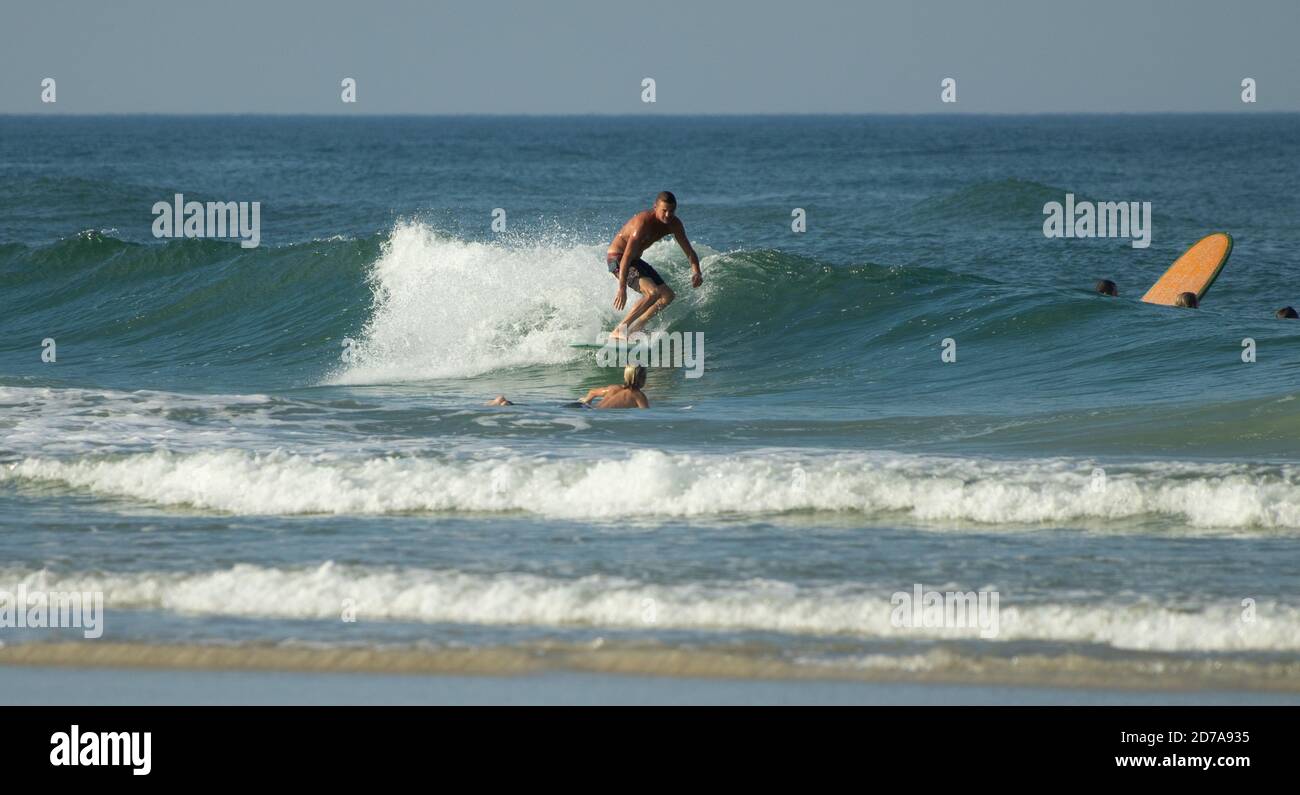Surfer riding a wave Stock Photo - Alamy