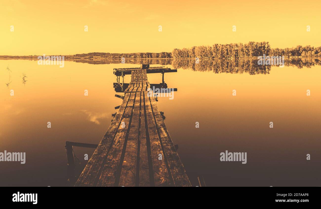 Tranquil summer morning scene with wooden bridge Stock Photo - Alamy