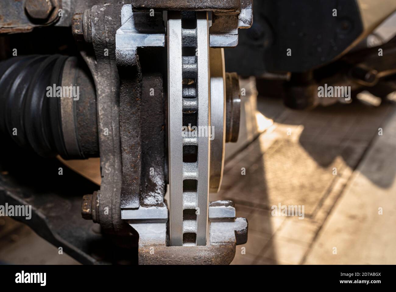 New anti-corrosion coated brake disc mounted on the front hub, a close ...