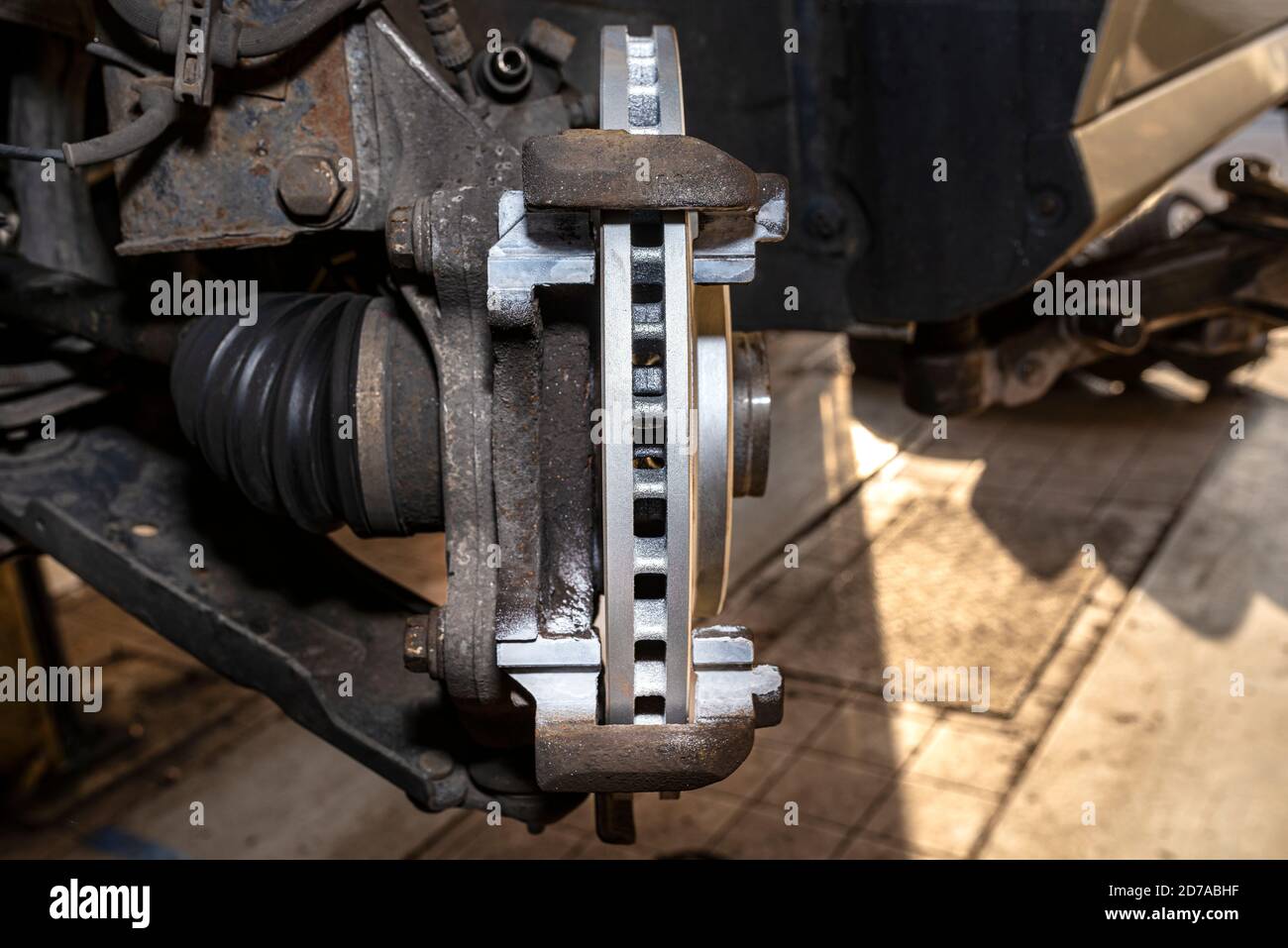 New anti-corrosion coated brake disc mounted on the front hub, a close ...