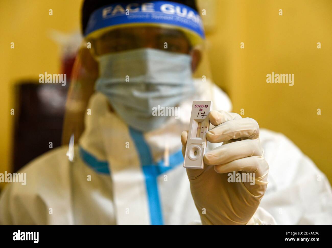 A health worker showing a negative result of Covid-19 Rapid Antigen ...