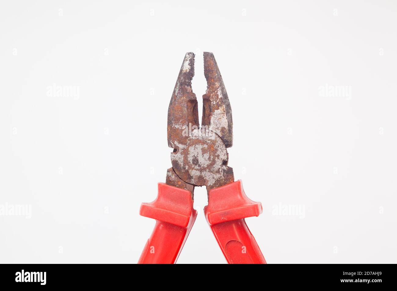 Open rusty red pliers against white background Stock Photo - Alamy