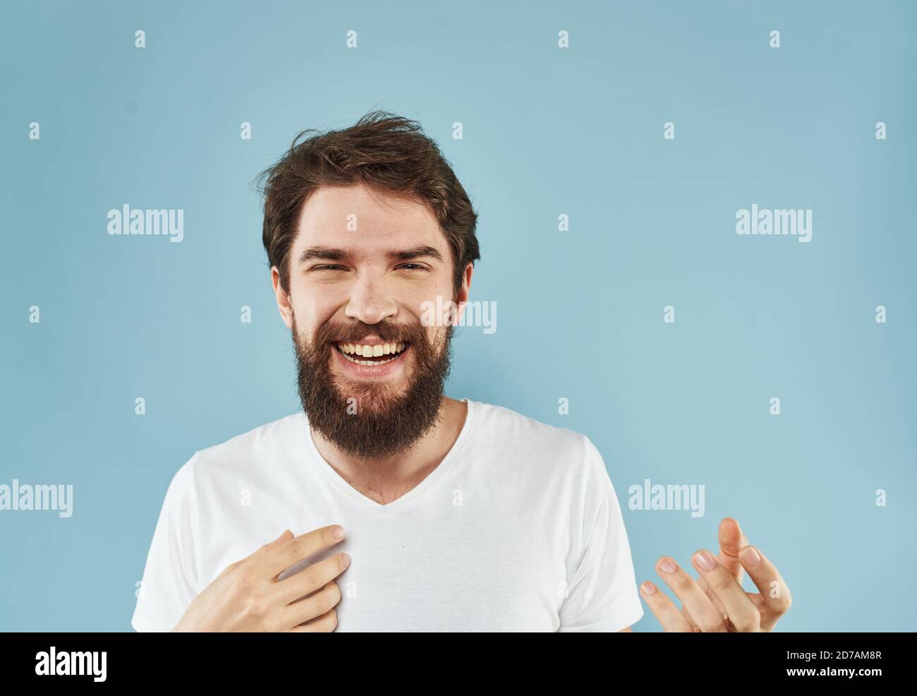 Happy guy in white t-shirt cropped look surprise joy Stock Photo - Alamy