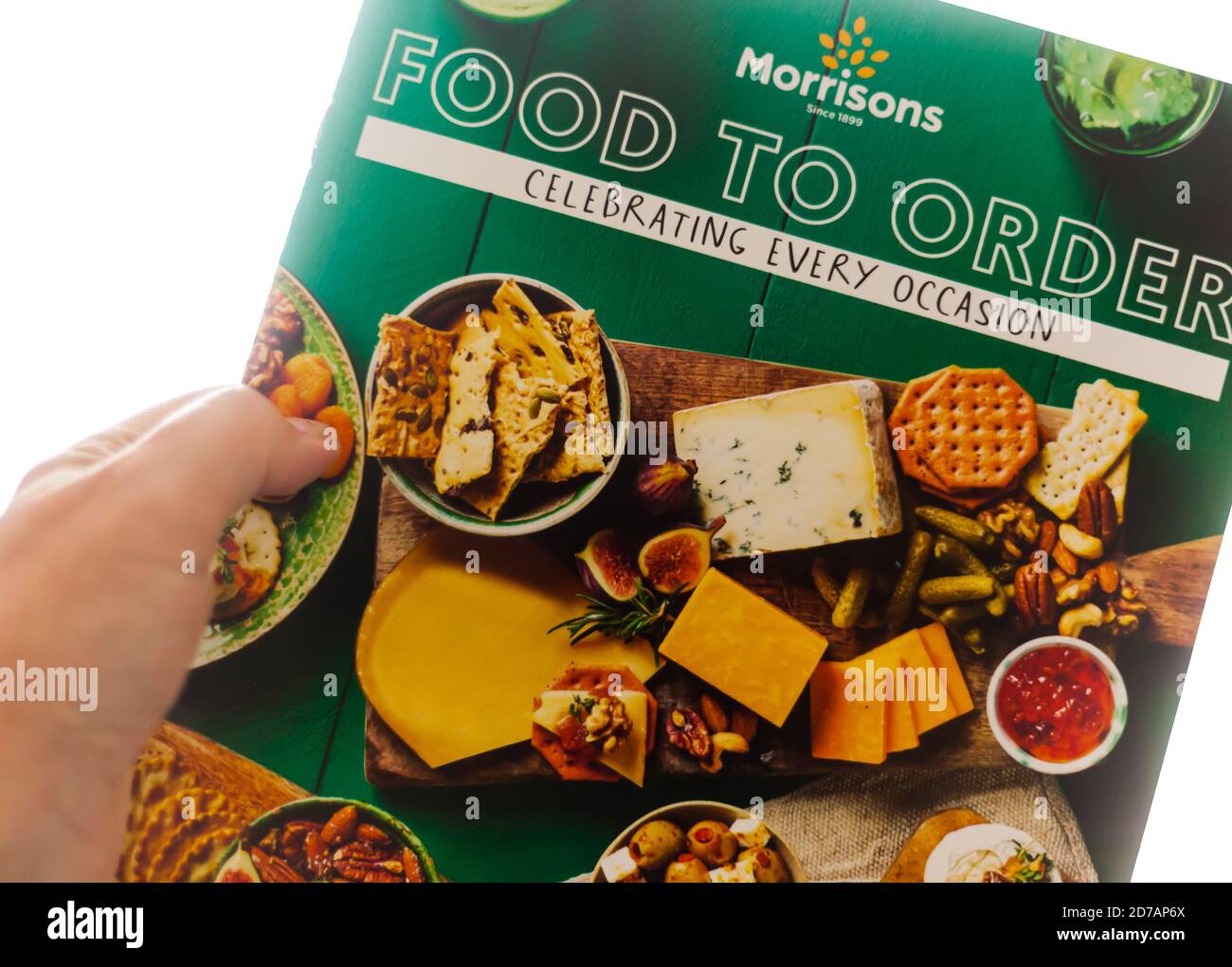 Close-up of a persons hand holding a Morrisons Food to Order Catalogue ...