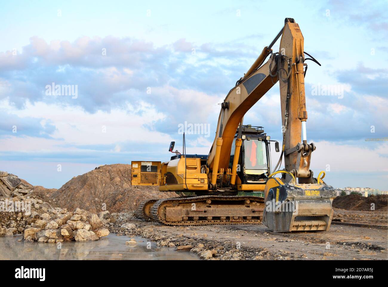 Excavator with crusher bucket for crushing concrete. Construction waste ...