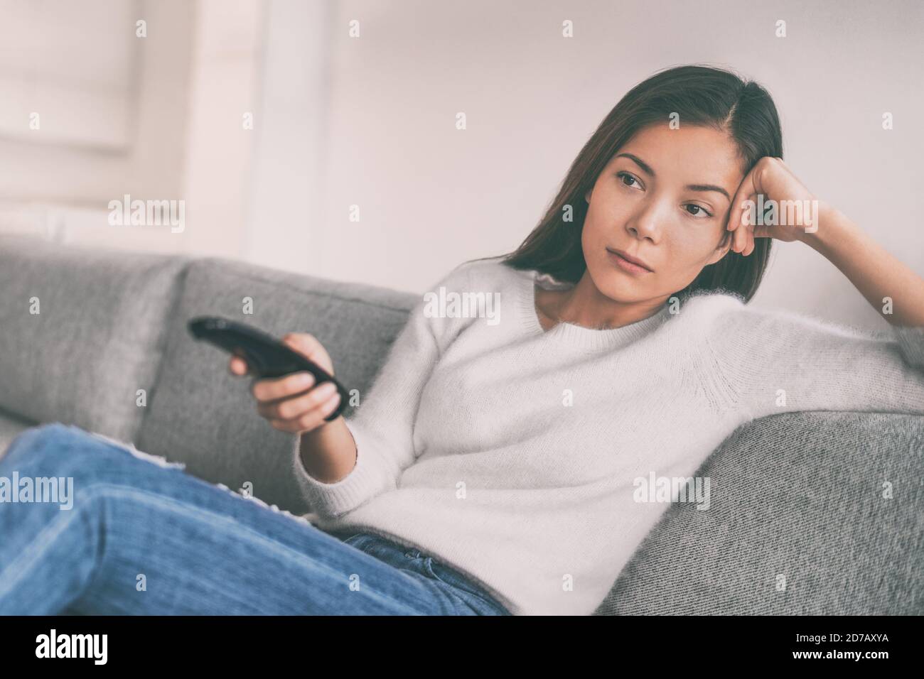 Staying at home inside bored asian woman watching boring tv shows ...