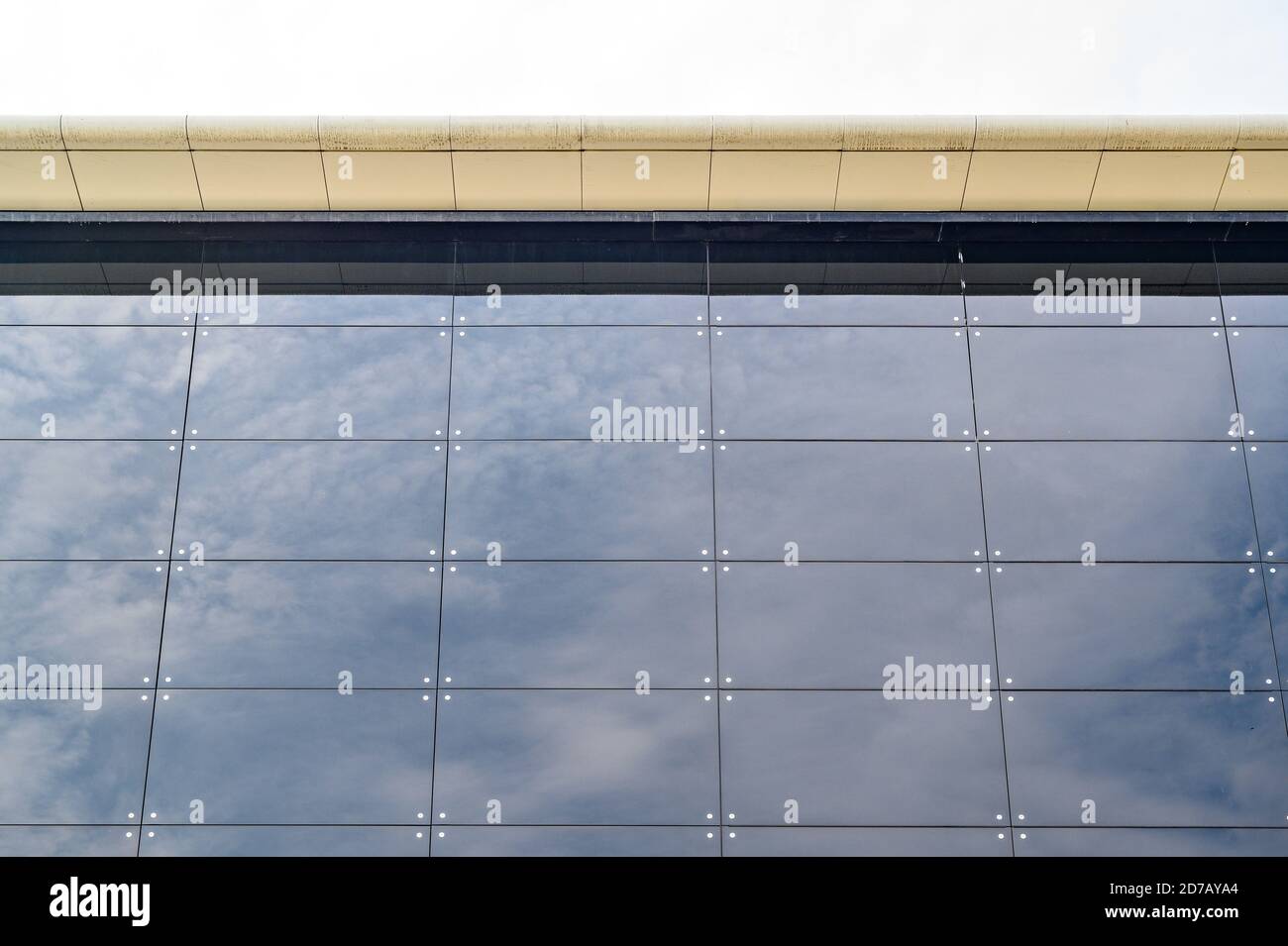 Low angle shot of modern glass windows with the reflection of the sky ...