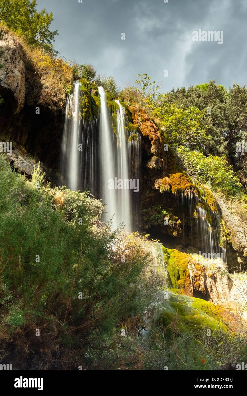 A large beautiful waterfall with a branch Stock Photo - Alamy