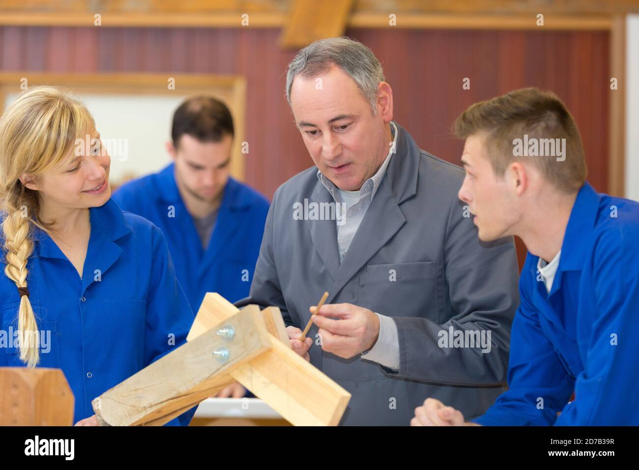 portrait of teacher assessing students creation Stock Photo - Alamy