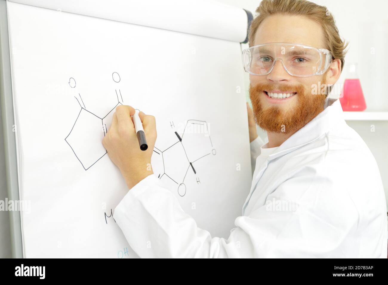 man in lab coat writing a formula Stock Photo - Alamy