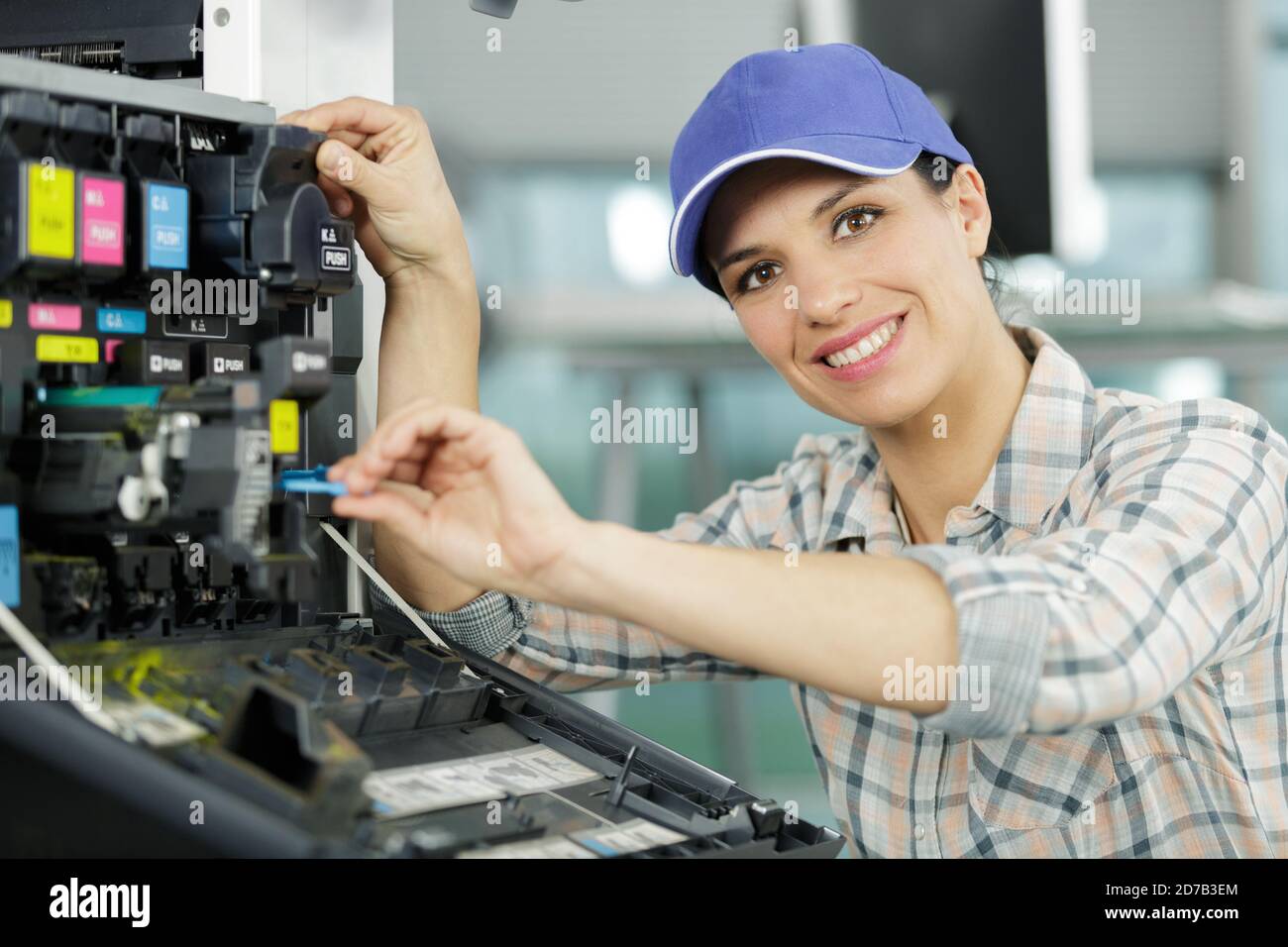 female technician fixing a printer Stock Photo - Alamy