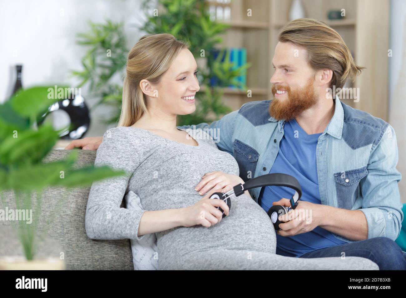 pregnant couple making baby listen to music Stock Photo - Alamy