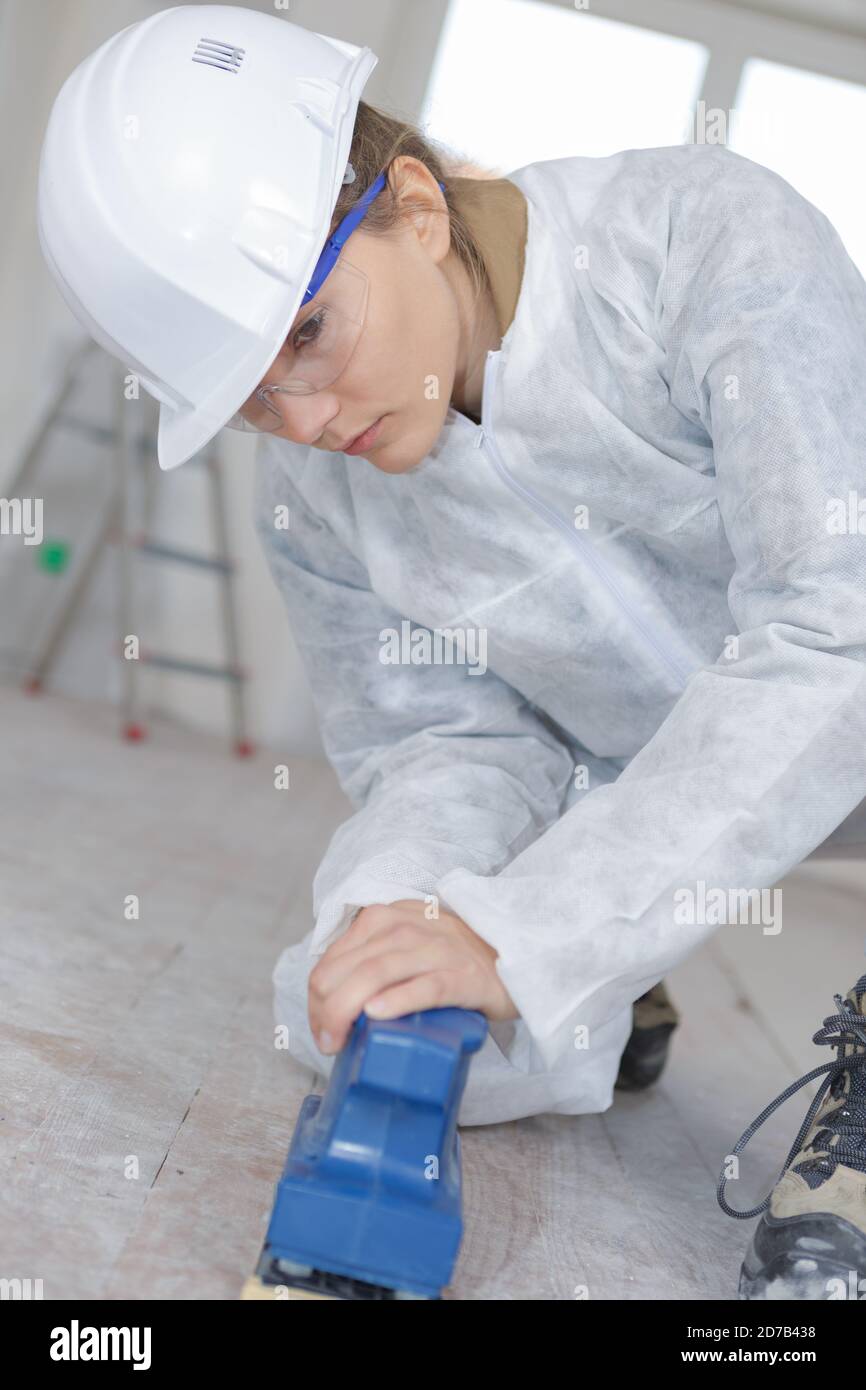 female worker using sander on floor Stock Photo - Alamy