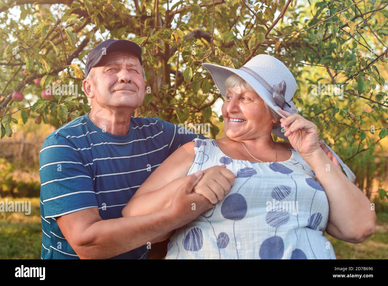Authentic outdoor shot of aging couple having fun in the garden and ...