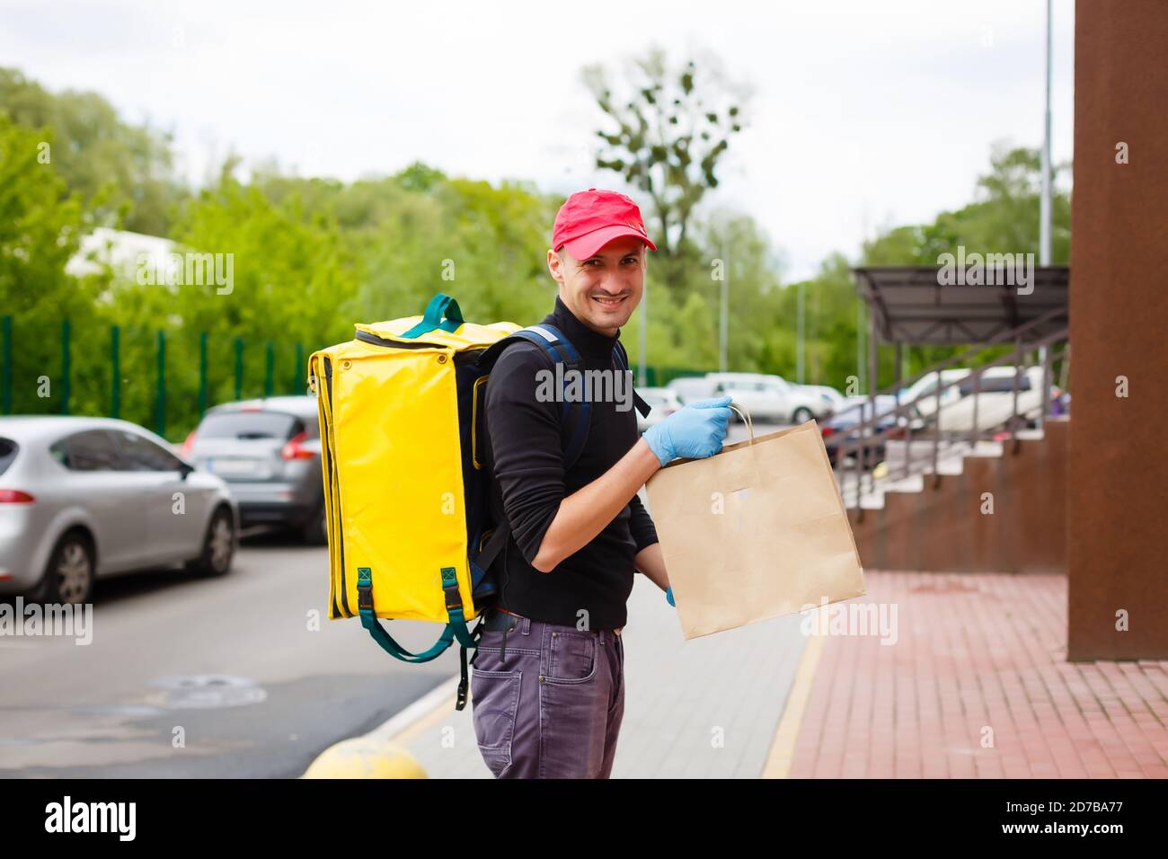 delivery boy of food delivery service walking down the street Stock ...