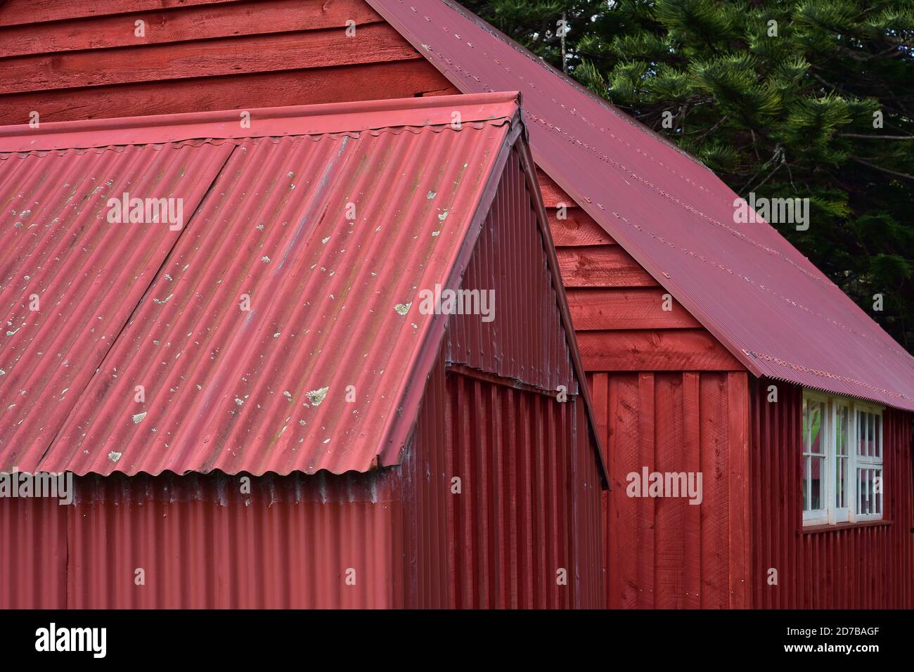Detail view of red painted vintage sheds made from corrugated sheet ...